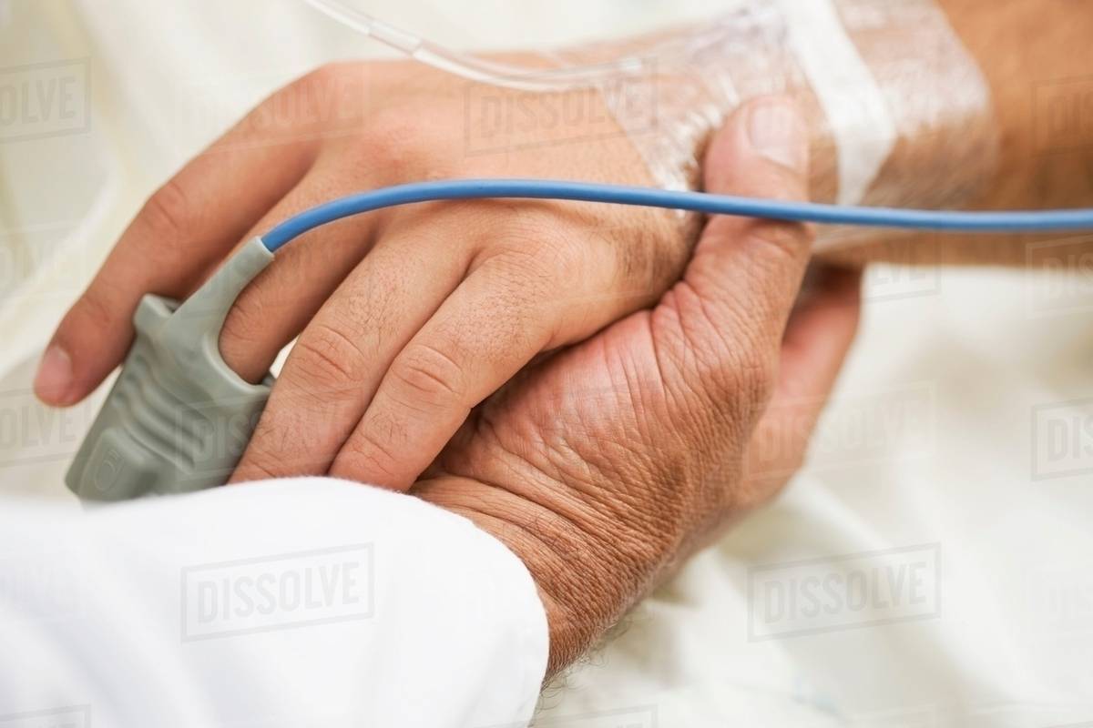 Person holding hospital patient's hand - Royalty-free Stock Photo ...