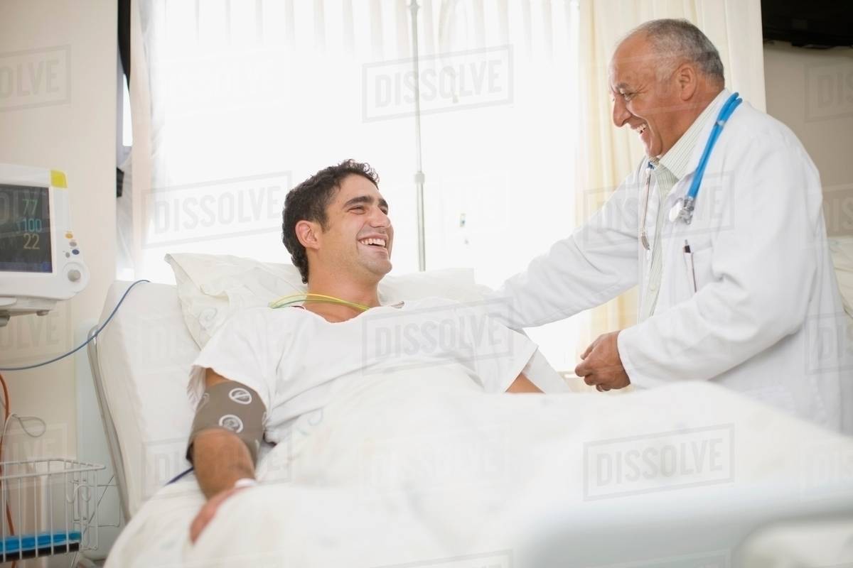 Doctor tending to hospital patient - Stock Photo - Dissolve