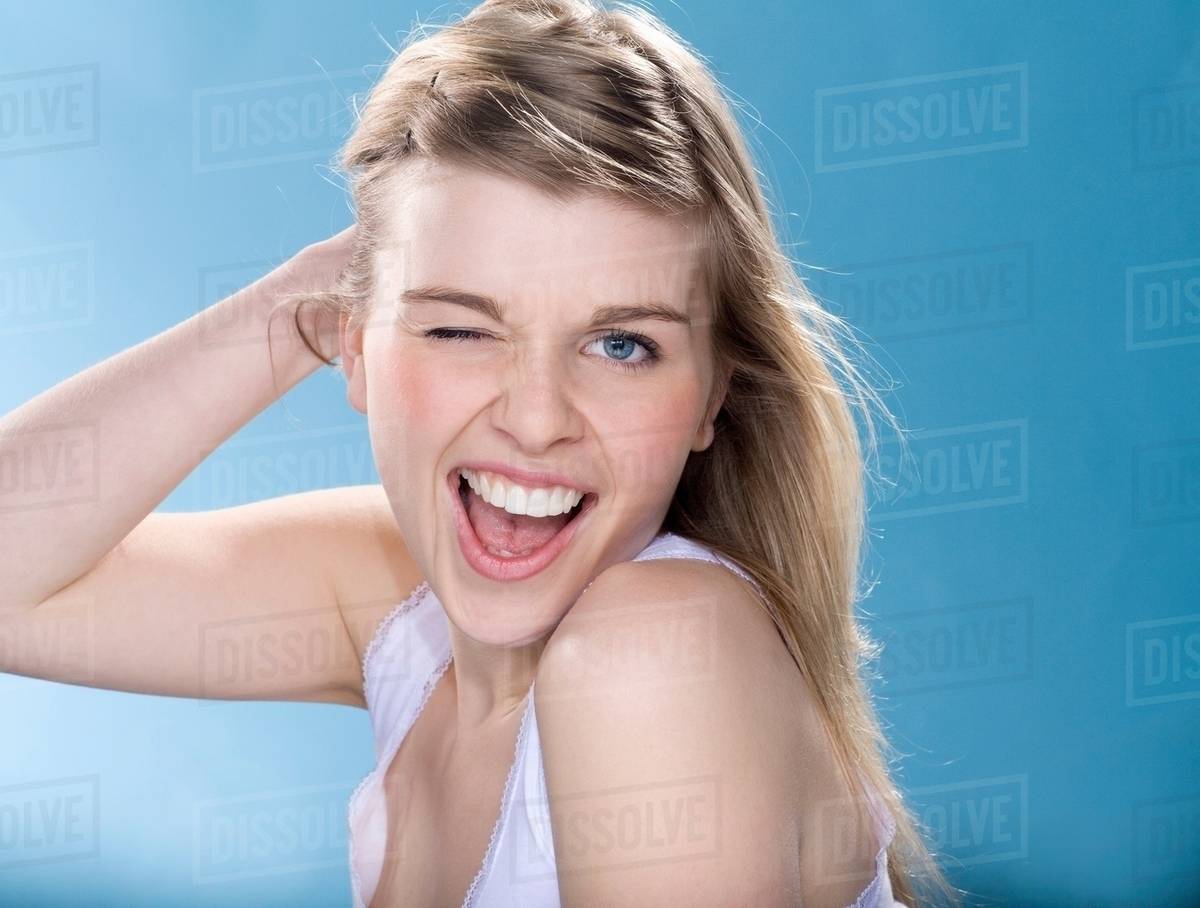 Smiling girl winking - Royalty-free Stock Photo | Dissolve