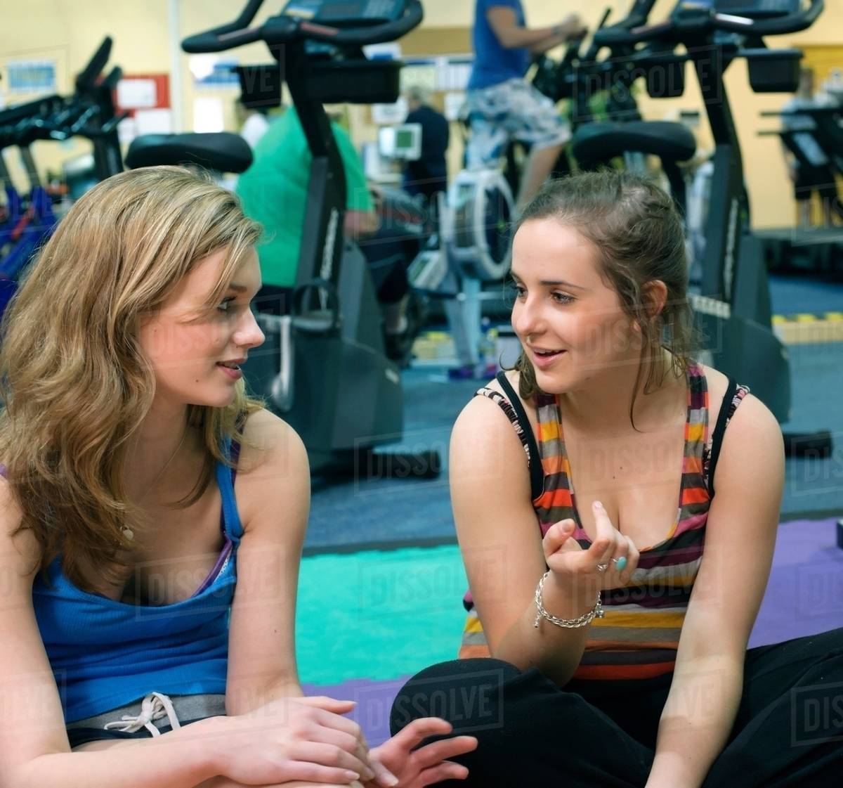 Women talking in gym - Stock Photo - Dissolve
