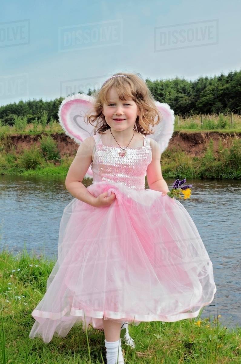 Girl wearing fairy costume by creek - Royalty-free Stock Photo | Dissolve
