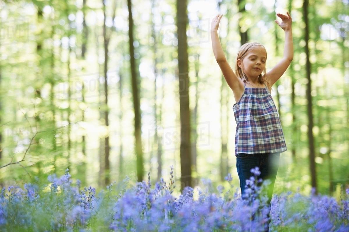 Girl dancing in field of flowers - Stock Photo - Dissolve