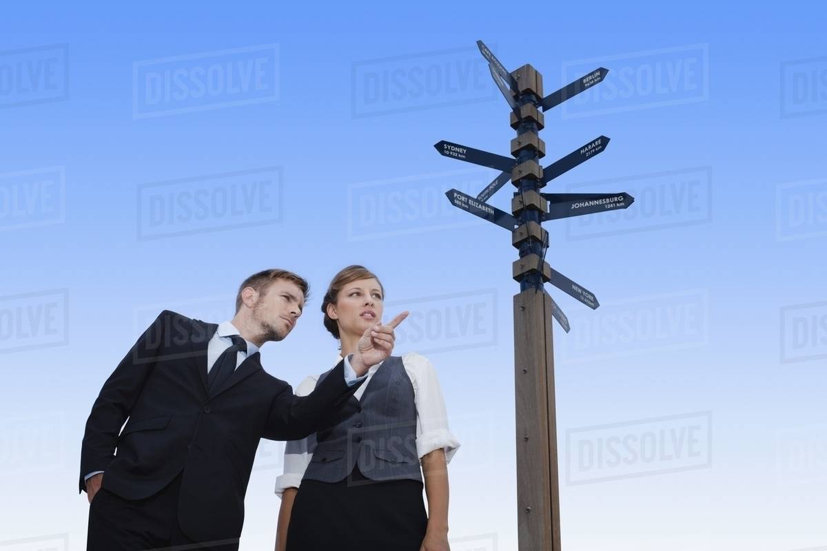 Business people at crossroads - Stock Photo - Dissolve
