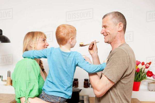 Family cooking together in kitchen - Stock Photo - Dissolve