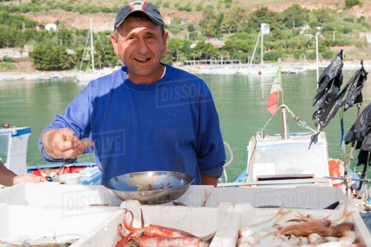 Fisherman selling fresh fish - Royalty-free Stock Photo | Dissolve