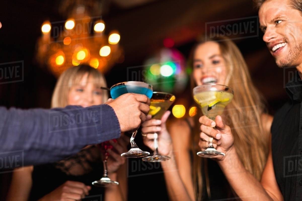 Smiling people having cocktails in club - Royalty-free Stock Photo ...
