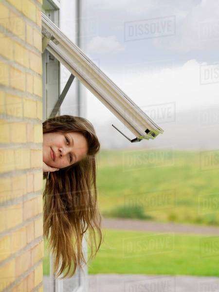 Girl peering outside window - Stock Photo - Dissolve