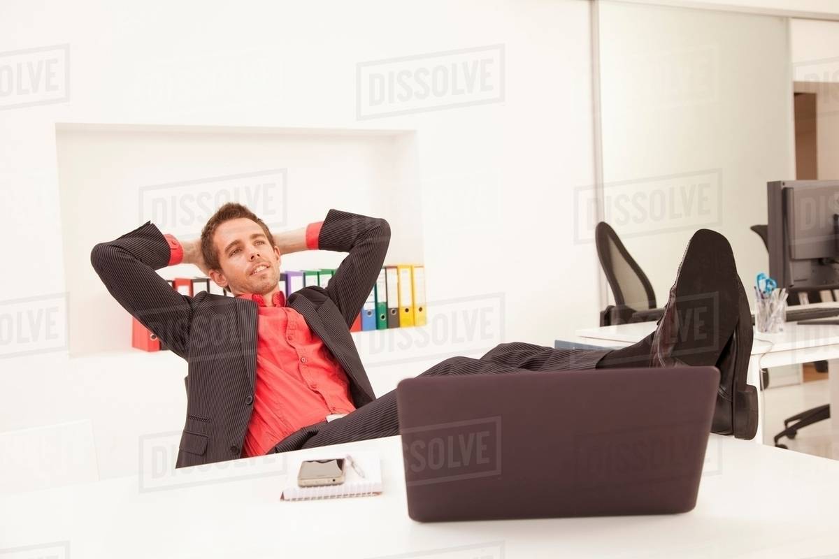 Businessman relaxing at desk - Royalty-free Stock Photo | Dissolve