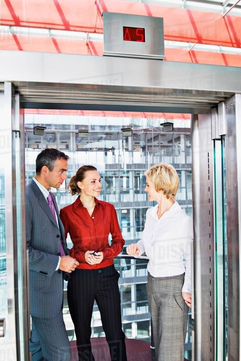Business people riding elevator - Royalty-free Stock Photo | Dissolve