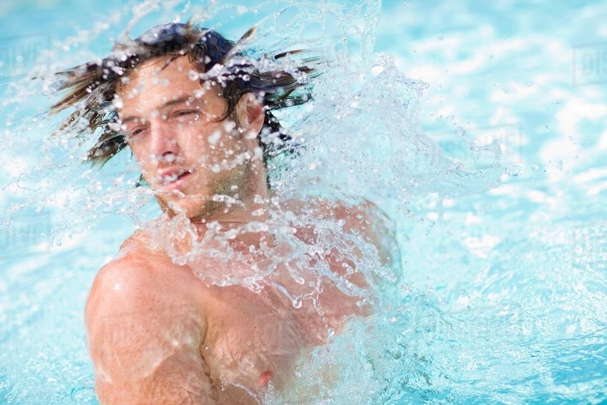 Man splashing in pool - Royalty-free Stock Photo | Dissolve