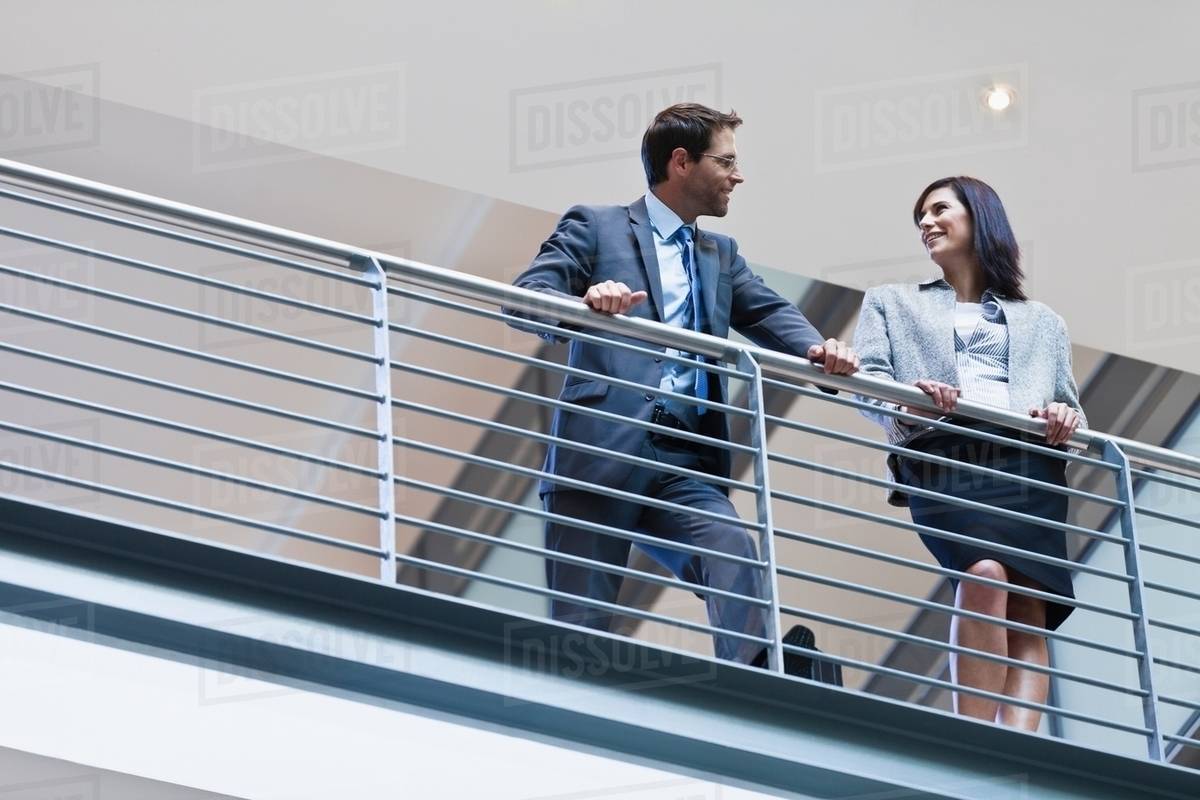 Business people talking on balcony - Royalty-free Stock Photo | Dissolve