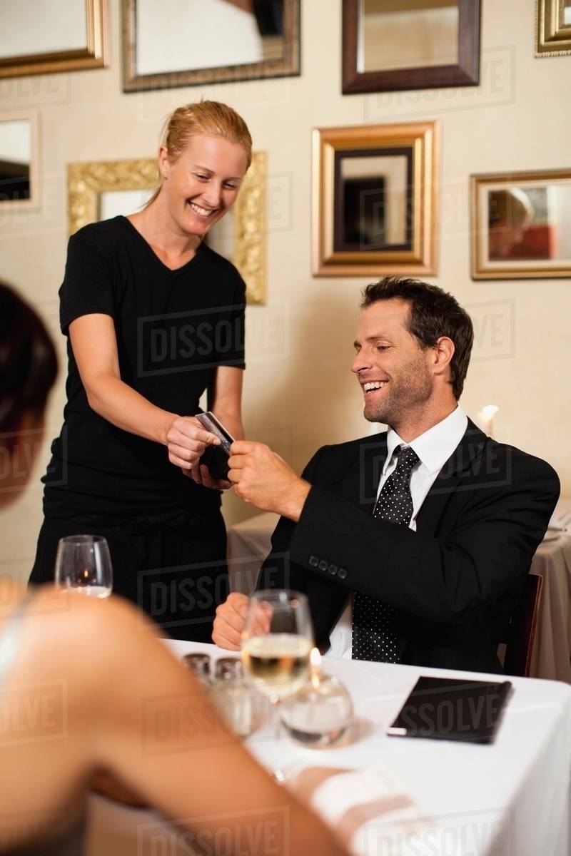 Man paying for dinner in restaurant - Stock Photo - Dissolve