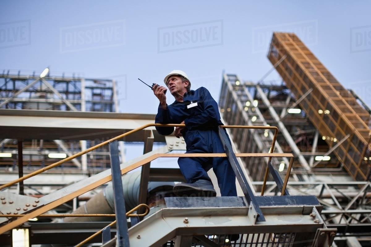 Worker using walkie talkie on site - Royalty-free Stock Photo | Dissolve
