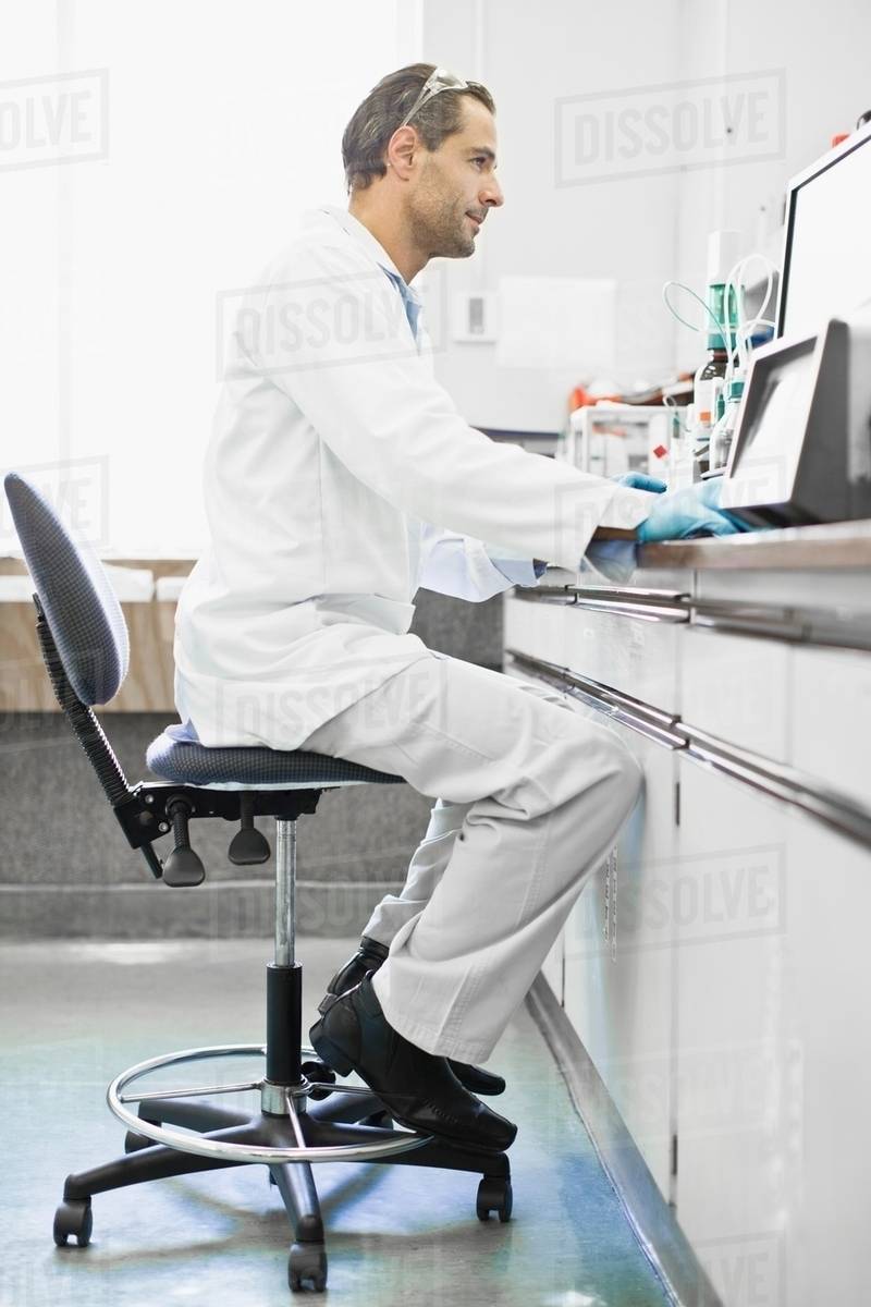 Scientist using computer in lab - Royalty-free Stock Photo | Dissolve