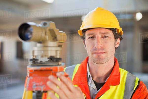 Worker using equipment on site - Stock Photo - Dissolve