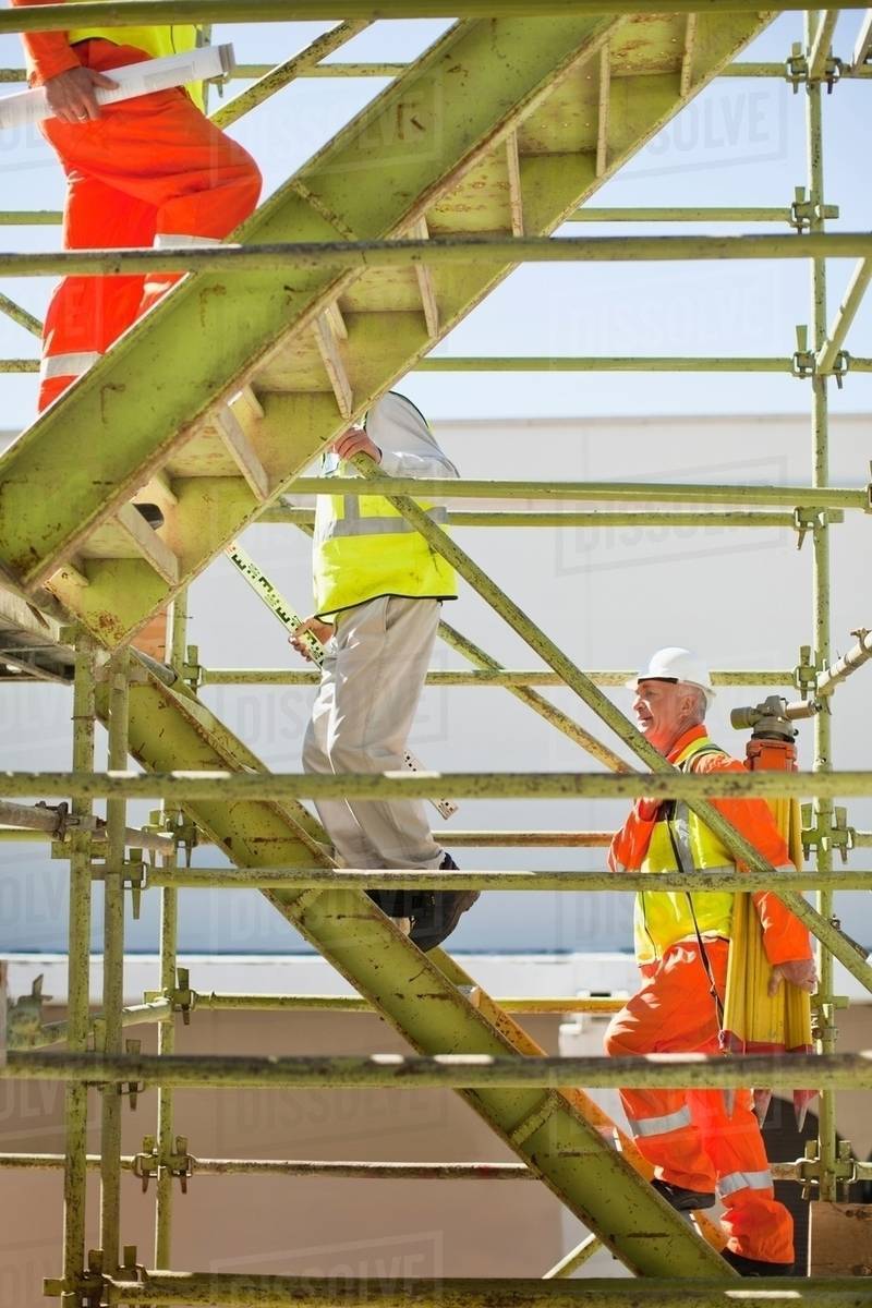 Workers climbing steps on site - Royalty-free Stock Photo | Dissolve