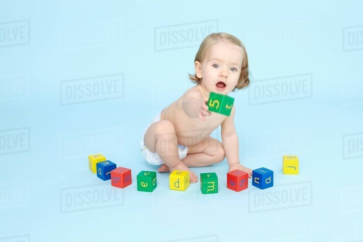 Baby girl playing with colored blocks - Royalty-free Stock Photo | Dissolve