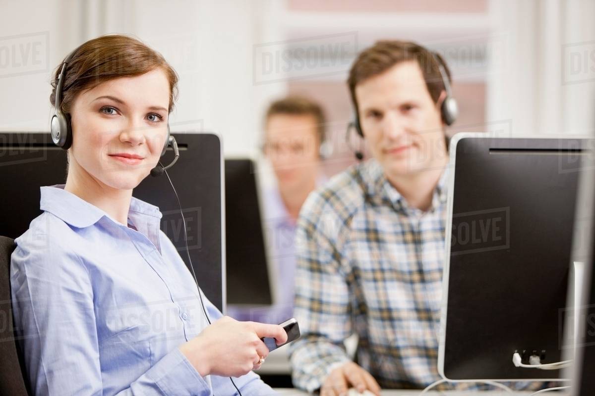 Business people working in headsets - Stock Photo - Dissolve