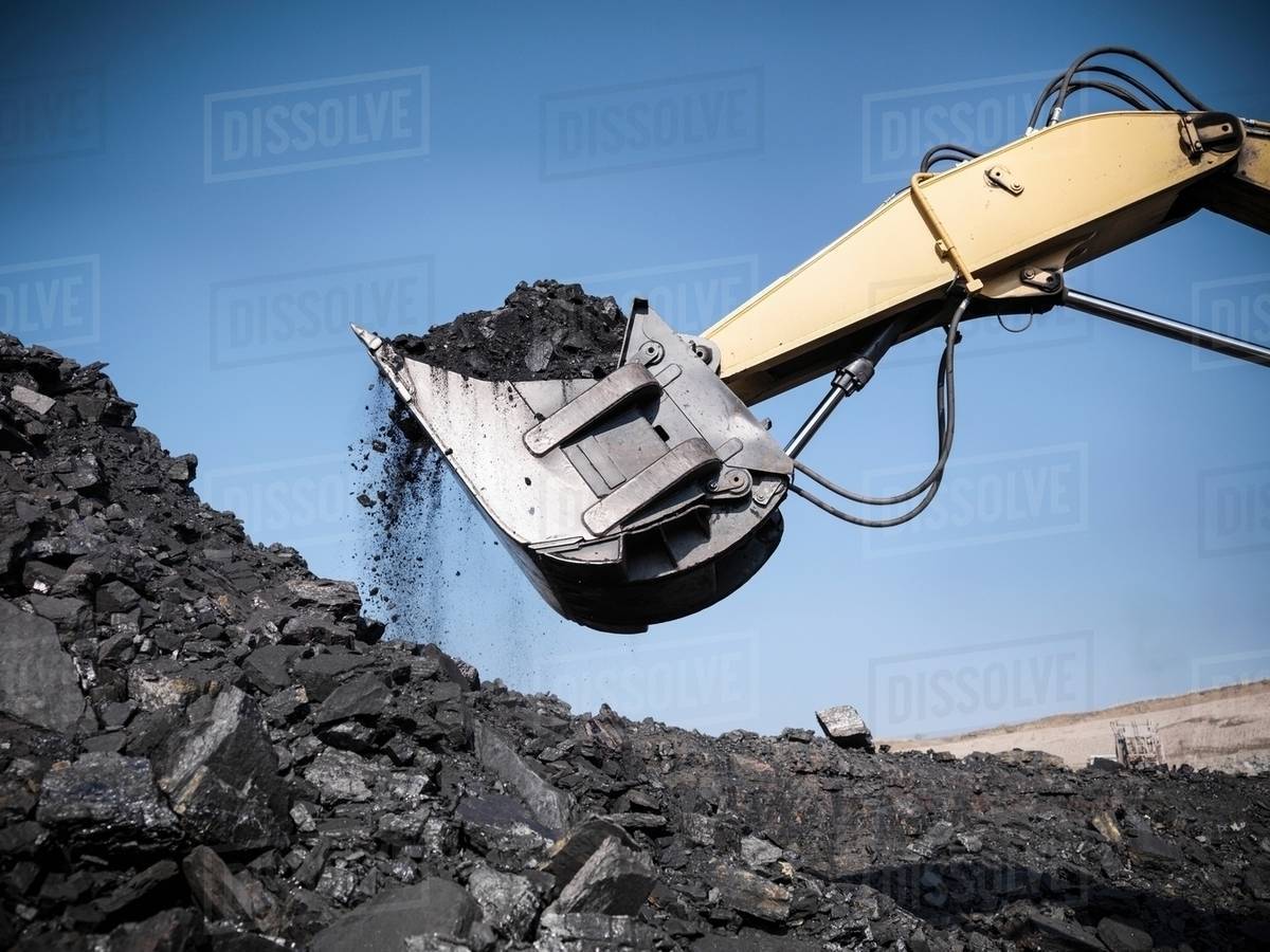 Digger lifting coal from opencast coalmine - Stock Photo - Dissolve