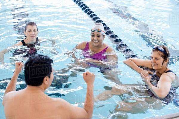 People relaxing in swimming pool - Royalty-free Stock Photo | Dissolve