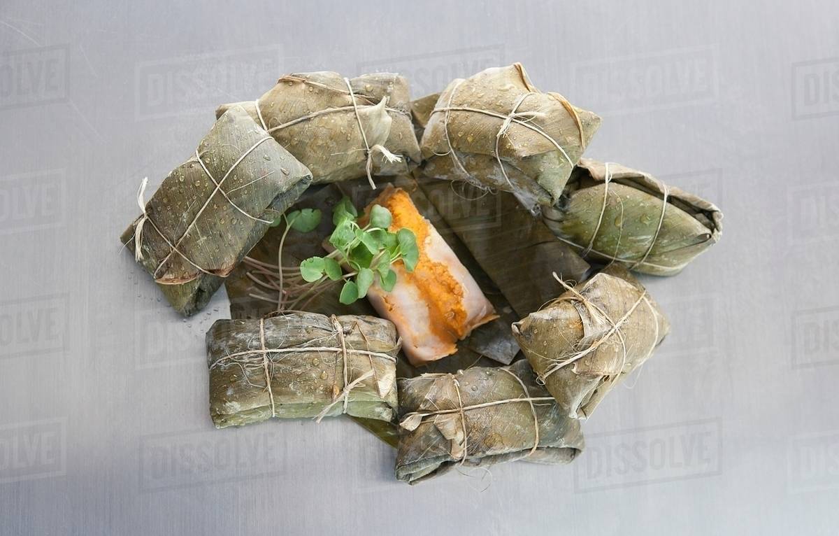 Tamales, wrapped in banana leaves - Royalty-free Stock Photo | Dissolve