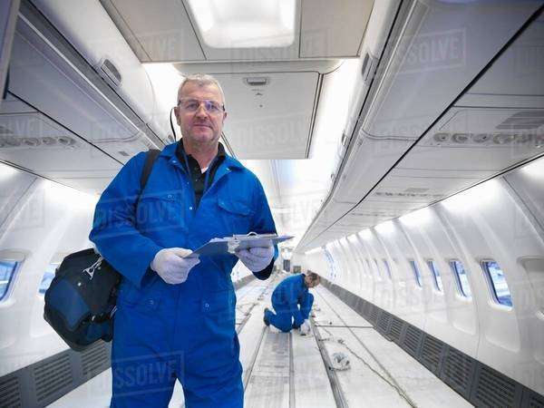 Aircraft engineer working on interior of 737 jet airplane - Stock Photo ...