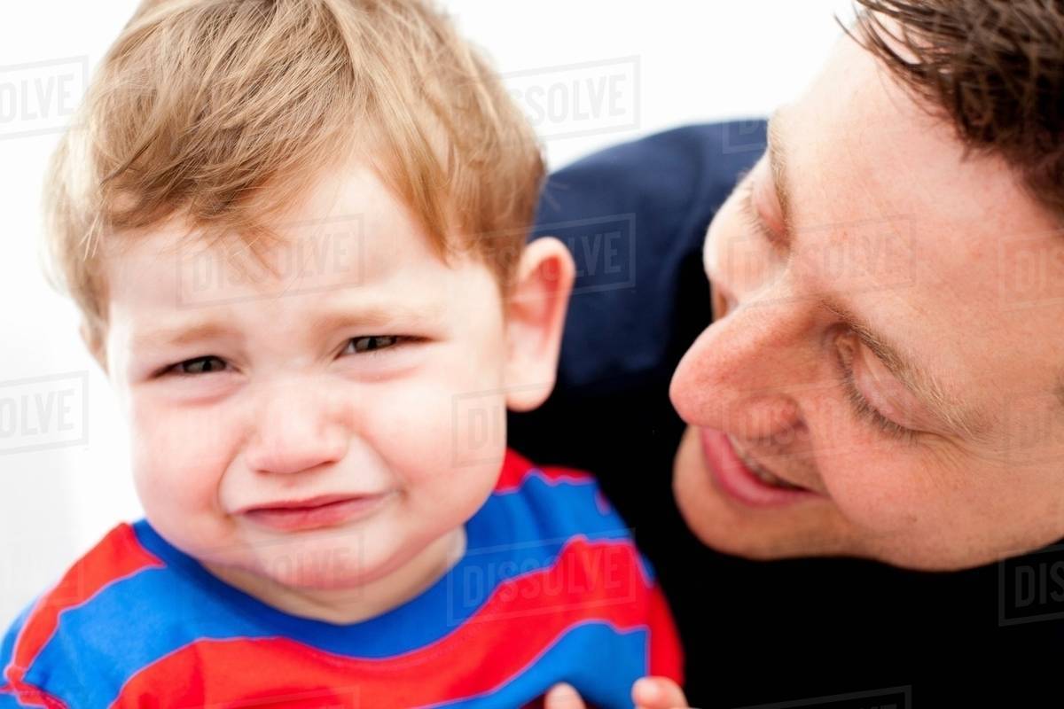 Father comforting crying son - Royalty-free Stock Photo | Dissolve
