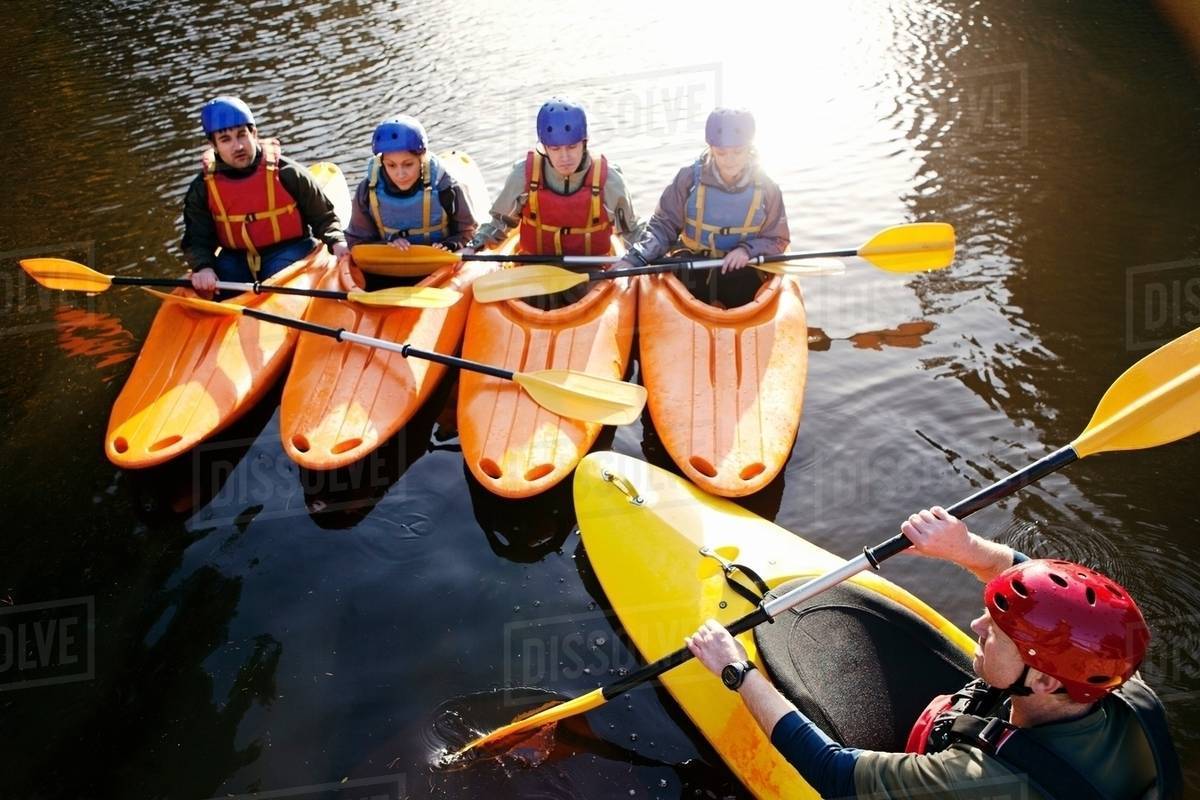 Teacher talking to students in kayaks - Royalty-free Stock Photo | Dissolve