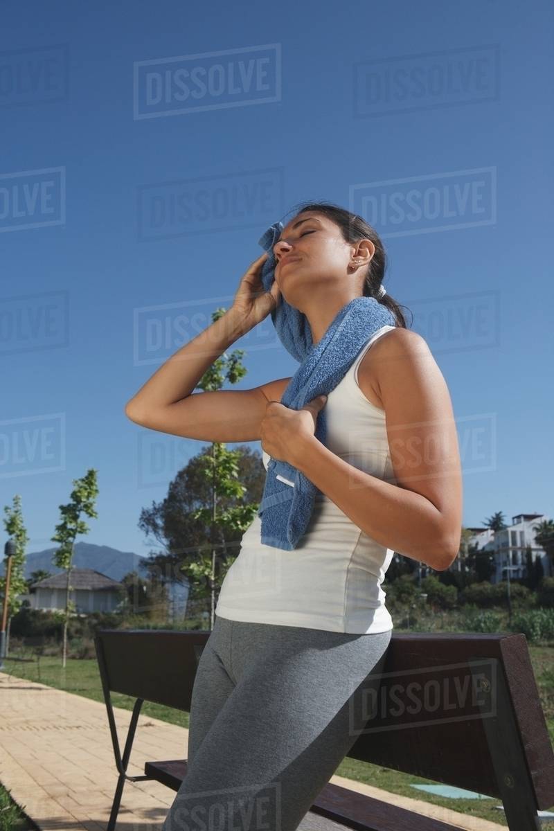 Runner wiping sweat from face - Stock Photo - Dissolve
