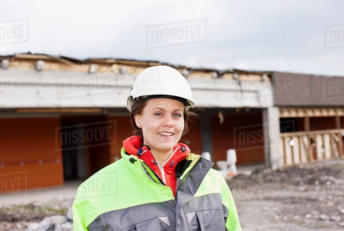 Worker standing on construction site - Royalty-free Stock Photo | Dissolve