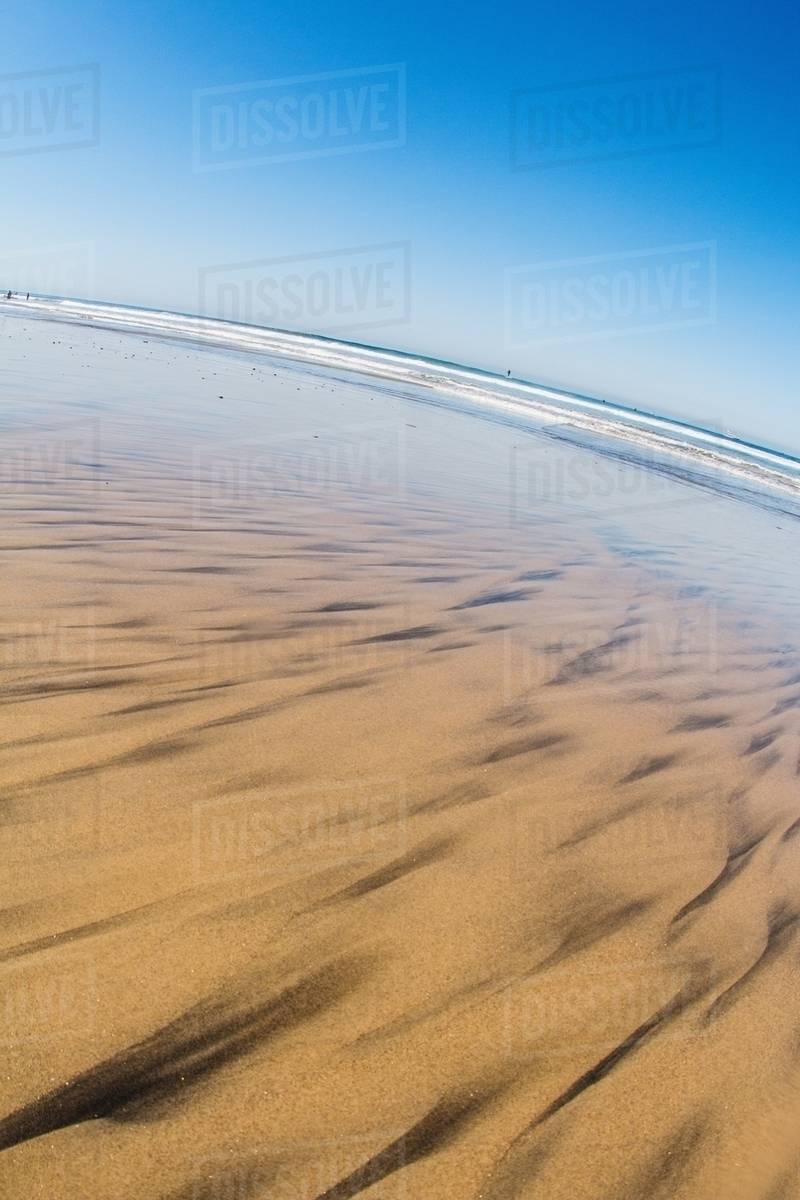 Sand with ocean in distance - Royalty-free Stock Photo | Dissolve
