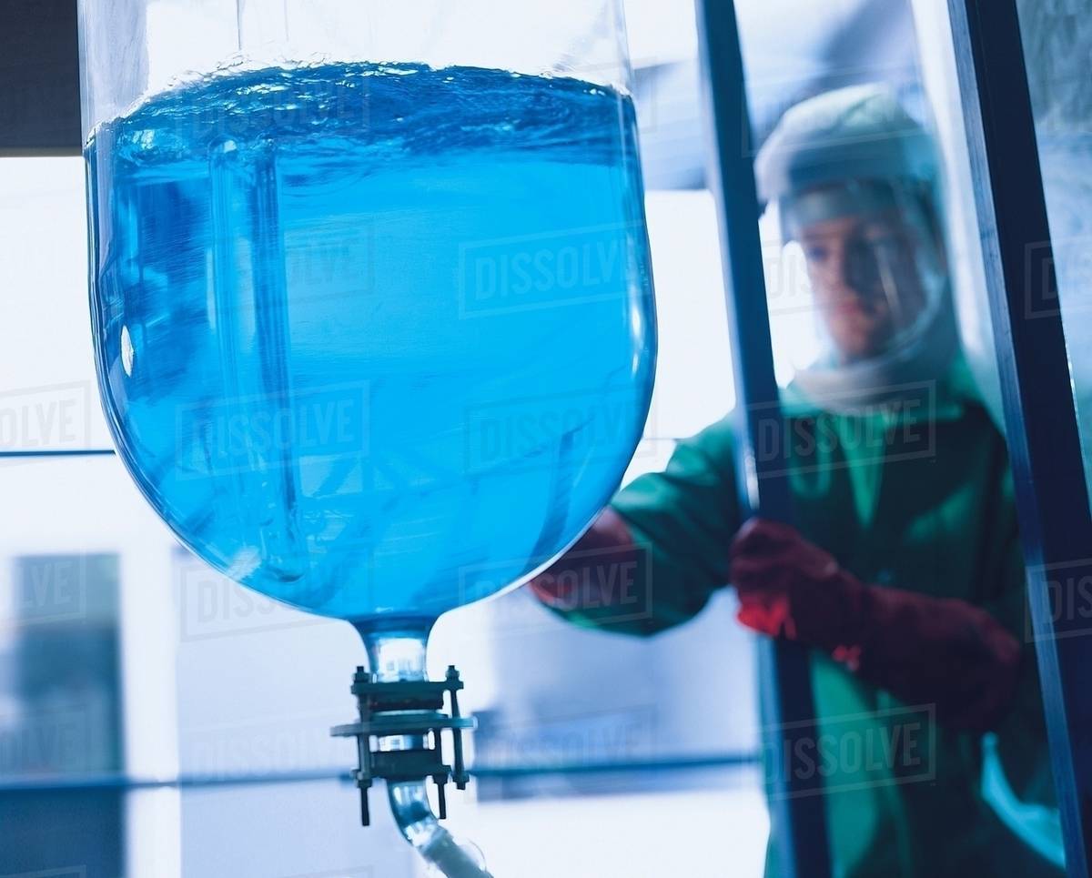 Worker mixing chemical in factory, close up - Stock Photo - Dissolve