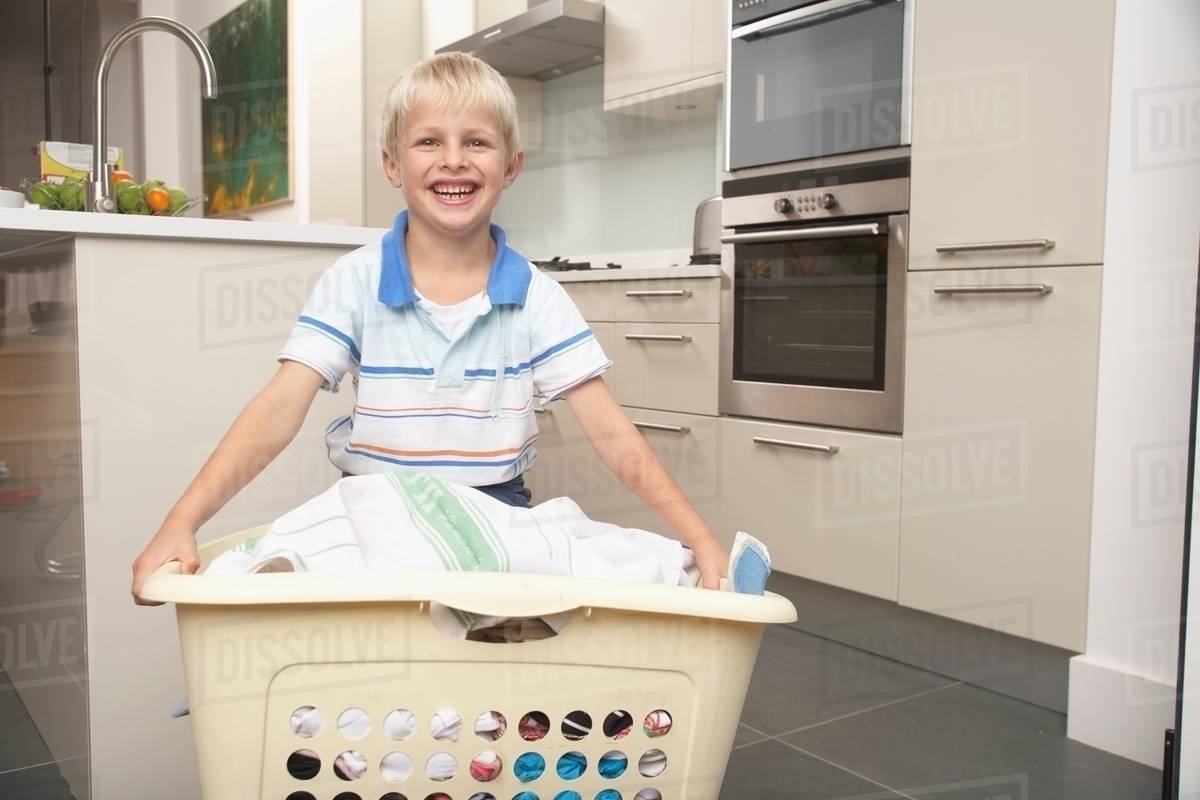 Boy carrying basket of laundry - Royalty-free Stock Photo | Dissolve
