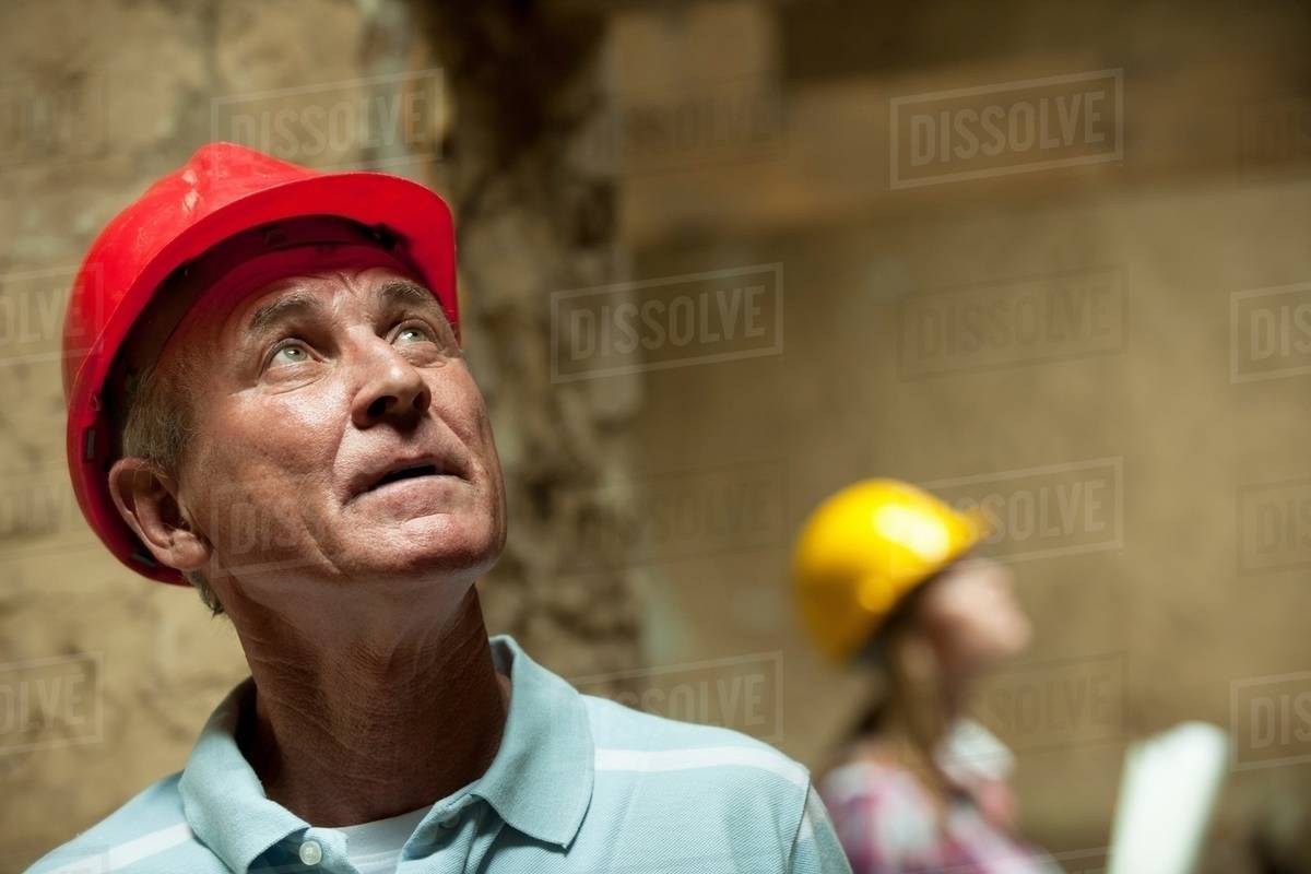 Construction worker wearing hard hat - Stock Photo - Dissolve
