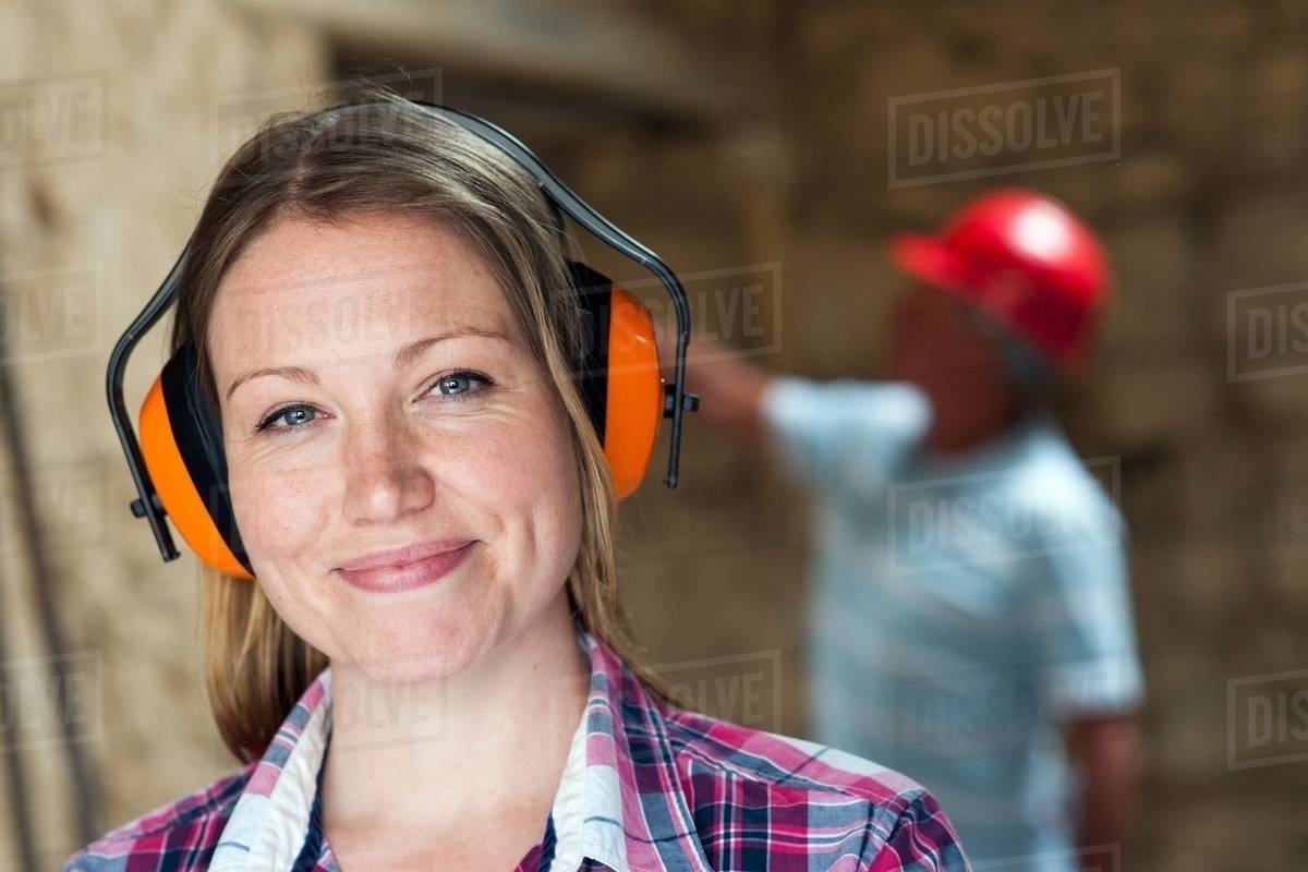 Construction worker wearing headphones - Stock Photo - Dissolve