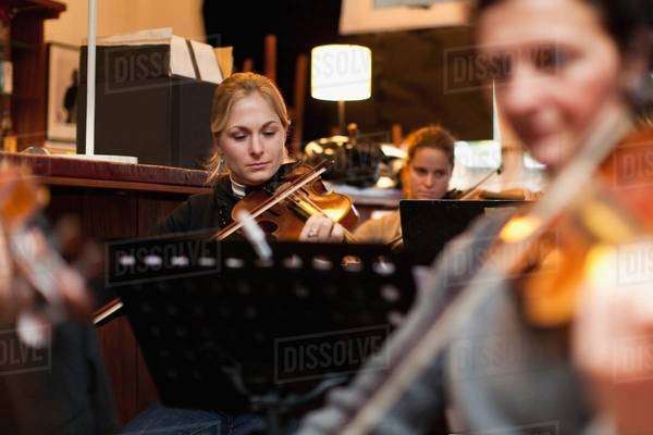 Violin player practicing with group - Royalty-free Stock Photo | Dissolve