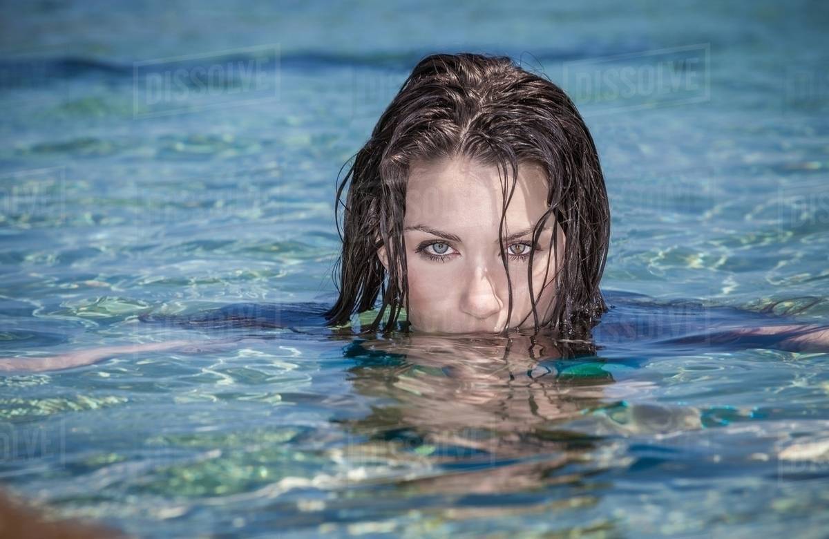 Portrait of beautiful young woman with face submerged in sea - Royalty ...