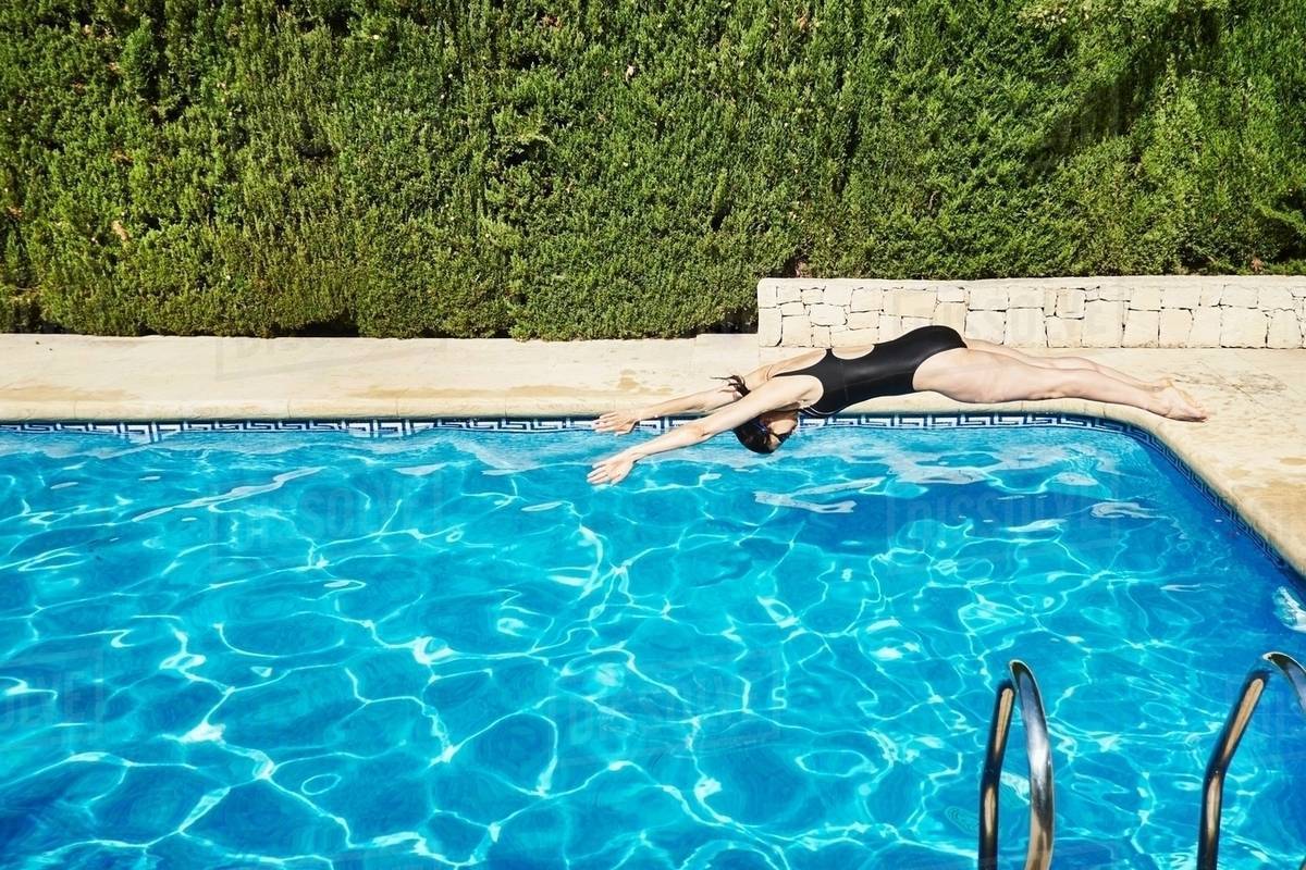 Mature woman diving into swimming pool - Royalty-free Stock Photo ...