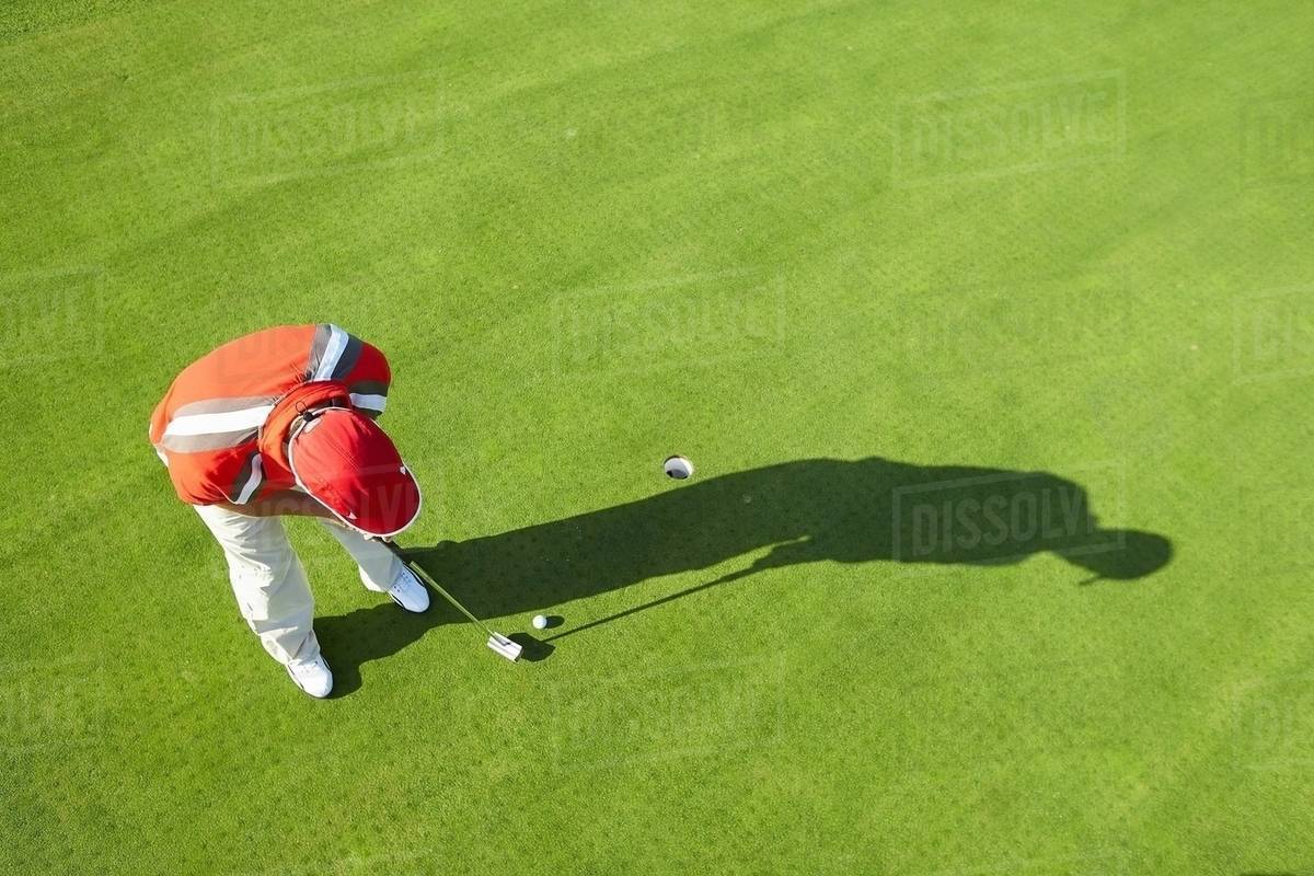 High view of golfer and shadow putting - Royalty-free Stock Photo ...