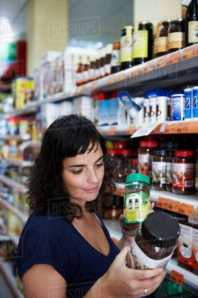 Woman comparing products - Stock Photo - Dissolve