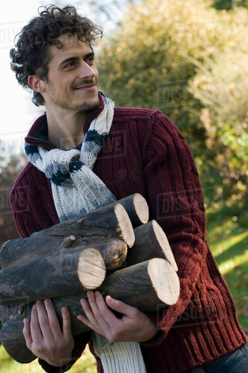 Man carrying logs - Royalty-free Stock Photo | Dissolve