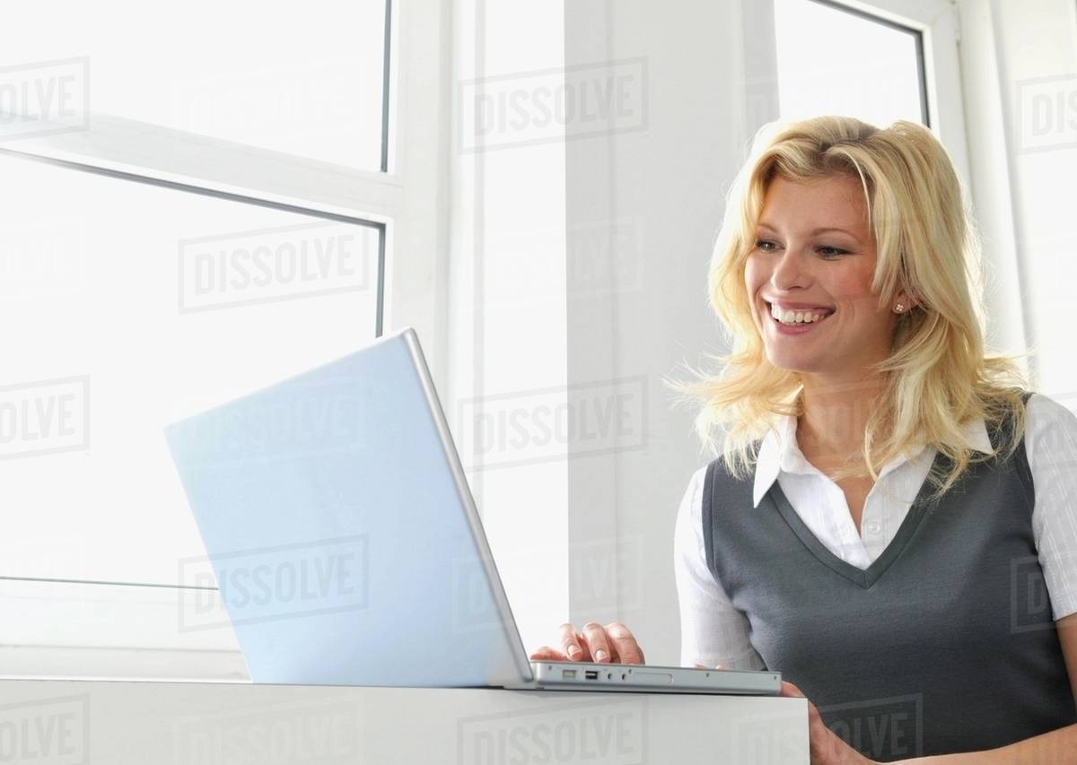 Happy business women at work - Royalty-free Stock Photo | Dissolve