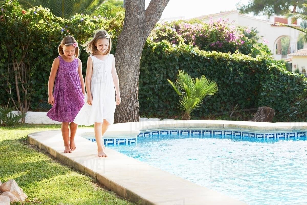 Girls playing by the pool - Royalty-free Stock Photo | Dissolve