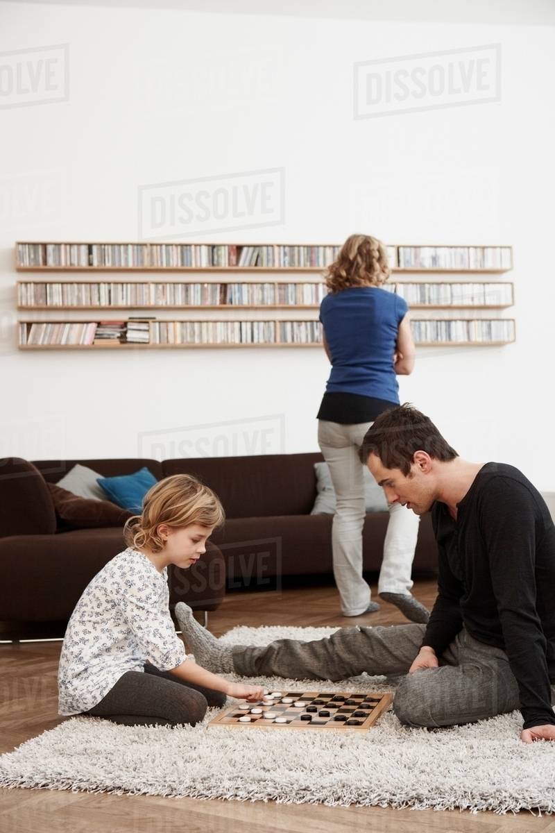Father and daughter playing checkers - Royalty-free Stock Photo | Dissolve