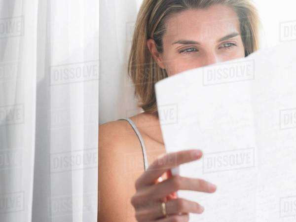 Woman reading a letter - Stock Photo - Dissolve