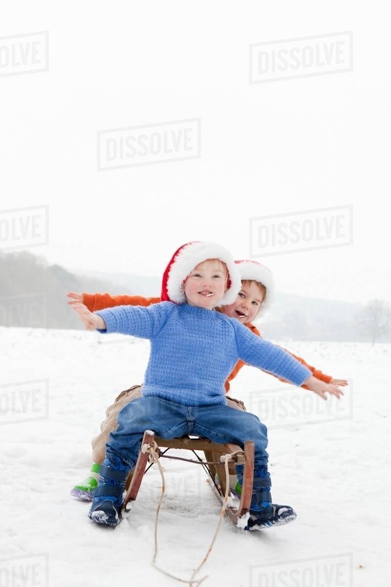 Two boys on a sledge - Stock Photo - Dissolve