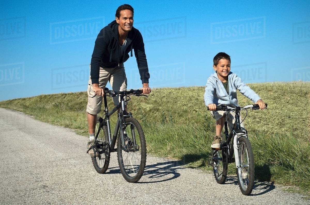 Father and son cycling - Royalty-free Stock Photo | Dissolve