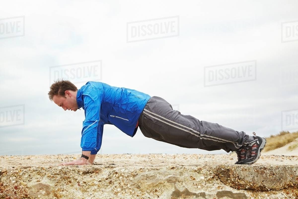 Man doing push ups outside on cloudy day - Royalty-free Stock Photo ...