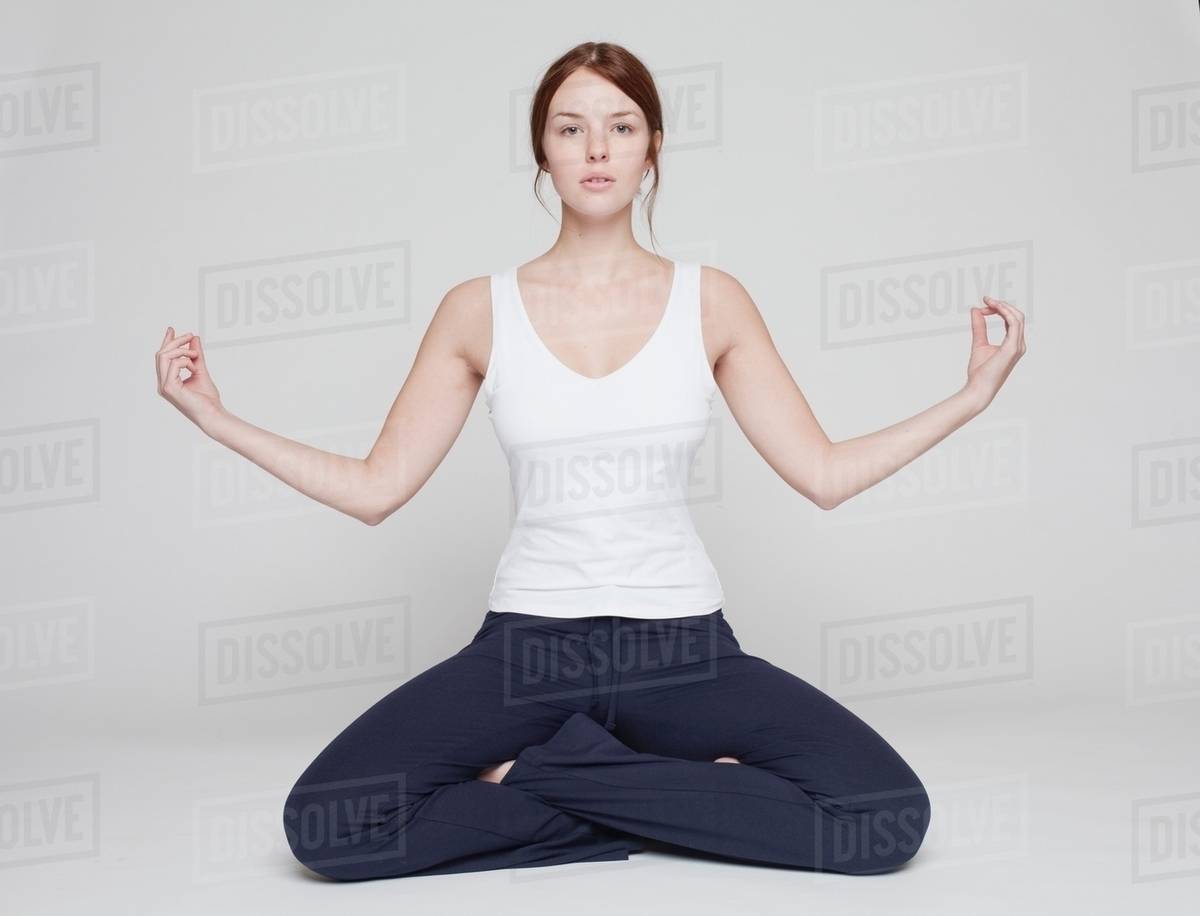 Girl in lotus position on white background - Stock Photo - Dissolve