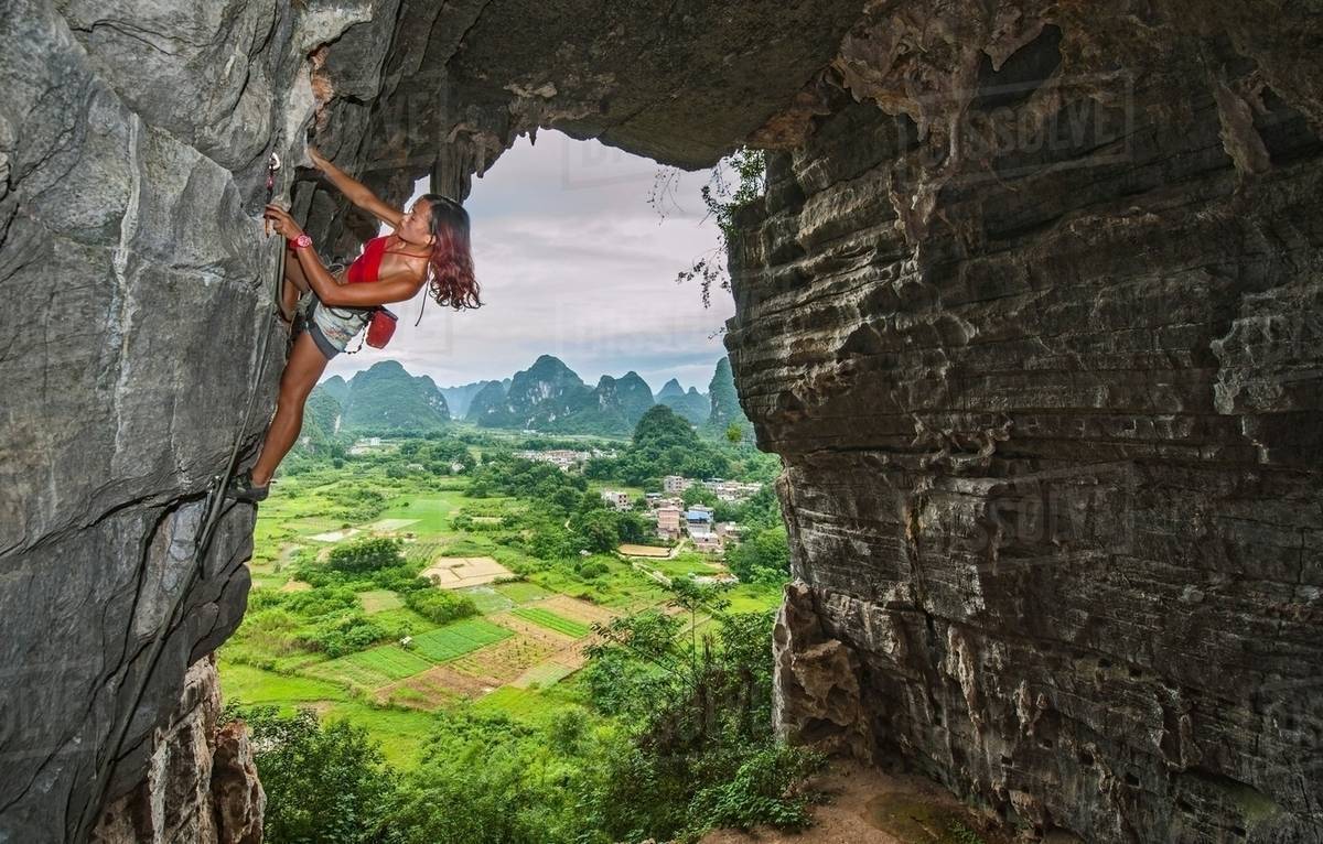 Female climber at treasure cave in Yangshuo, Guangxi Zhuang, China ...